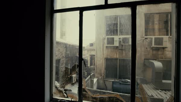 Window view at collapsed, half-ruined buildings in ghetto city block ...