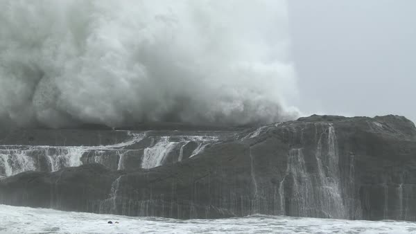 Huge waves crash ashore as major hurricane approaches the coast - Stock ...