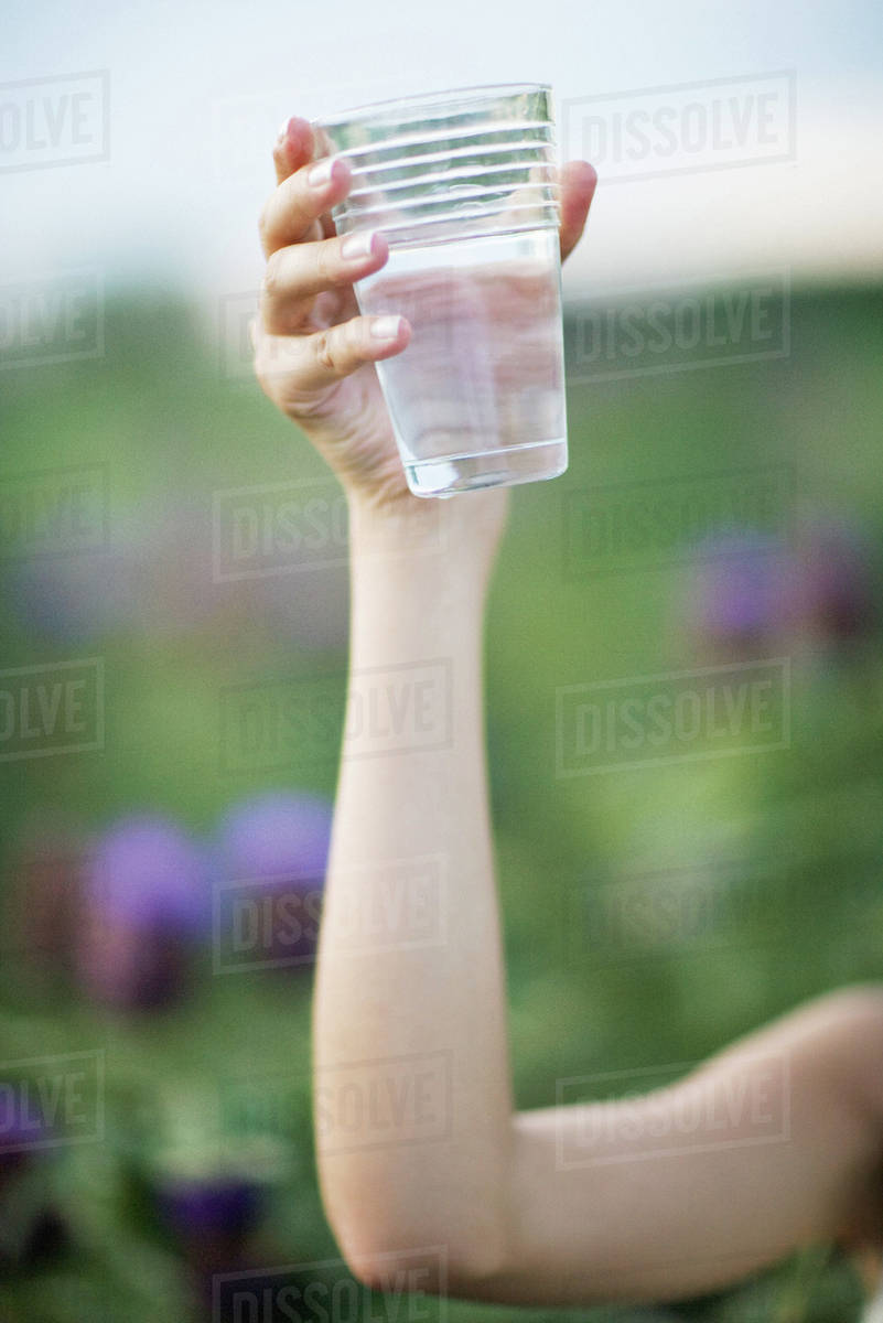 Woman holding up glass of water, cropped - Royalty-free Stock Photo ...