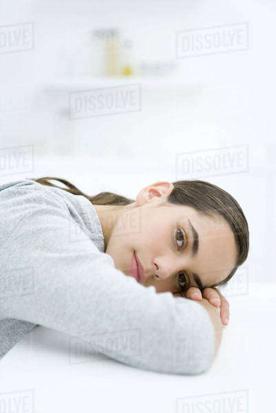 Female resting head on arms, looking at camera - Royalty-free Stock ...
