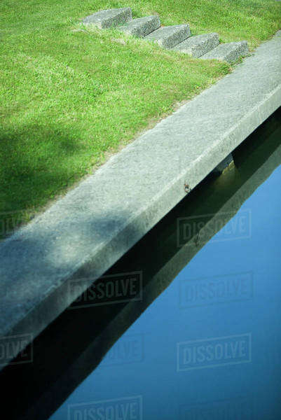 Stone path and steps on embankment beside water - Royalty-free Stock ...