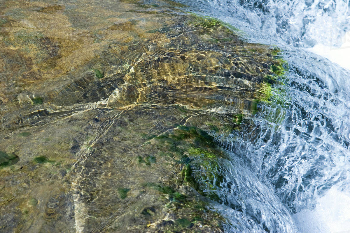 Water flowing over rock, close-up - Stock Photo - Dissolve