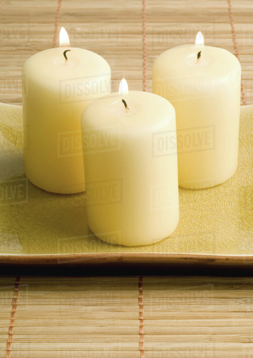 Three lit candles - Royalty-free Stock Photo | Dissolve