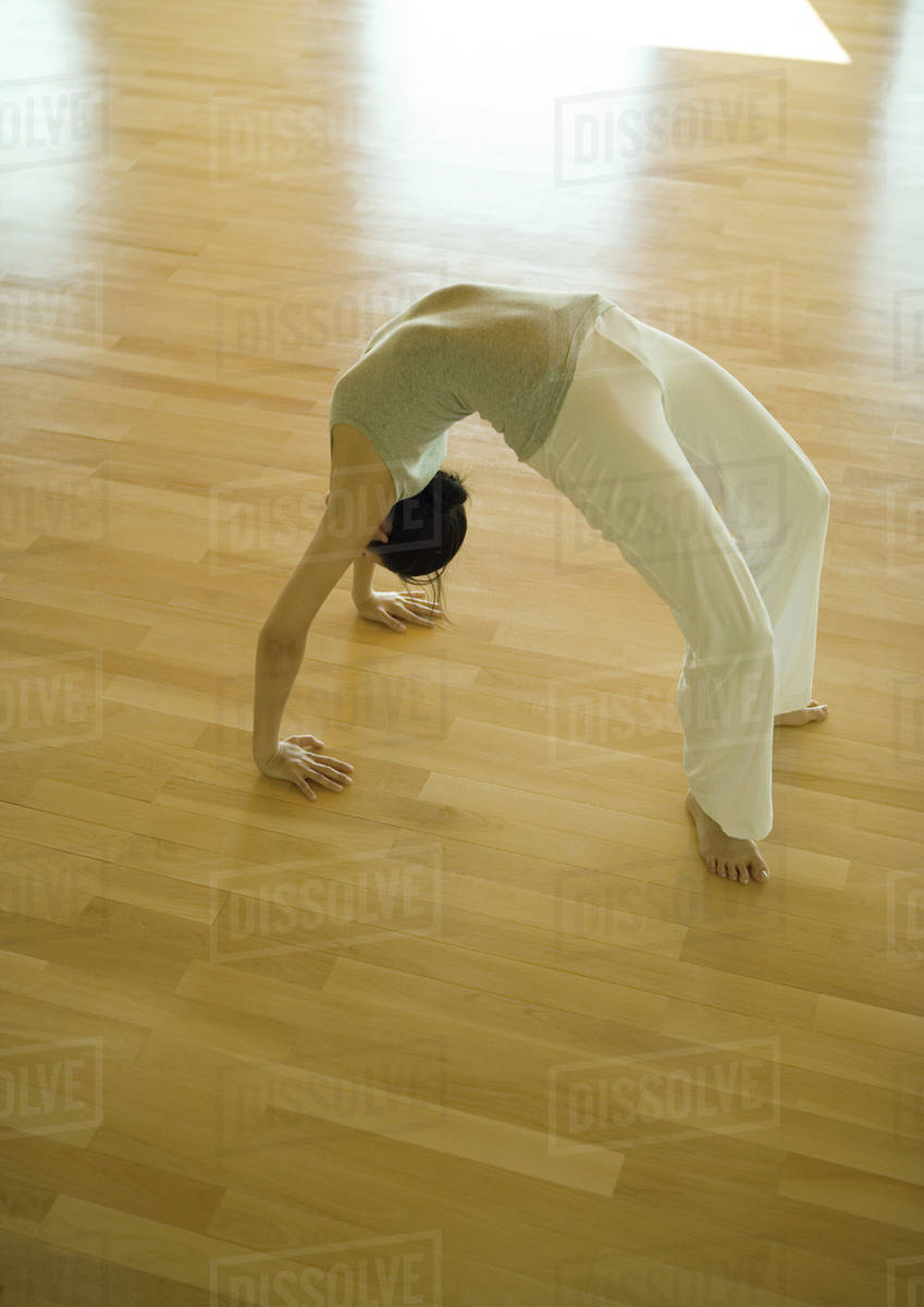 Woman doing bridge position, high angle view - Stock Photo - Dissolve