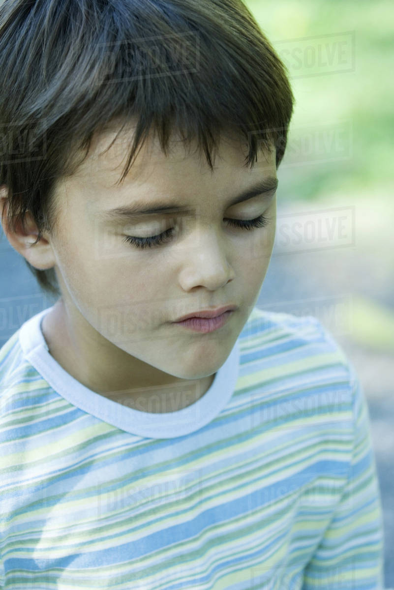 Boy, eyes closed, head and shoulders - Stock Photo - Dissolve