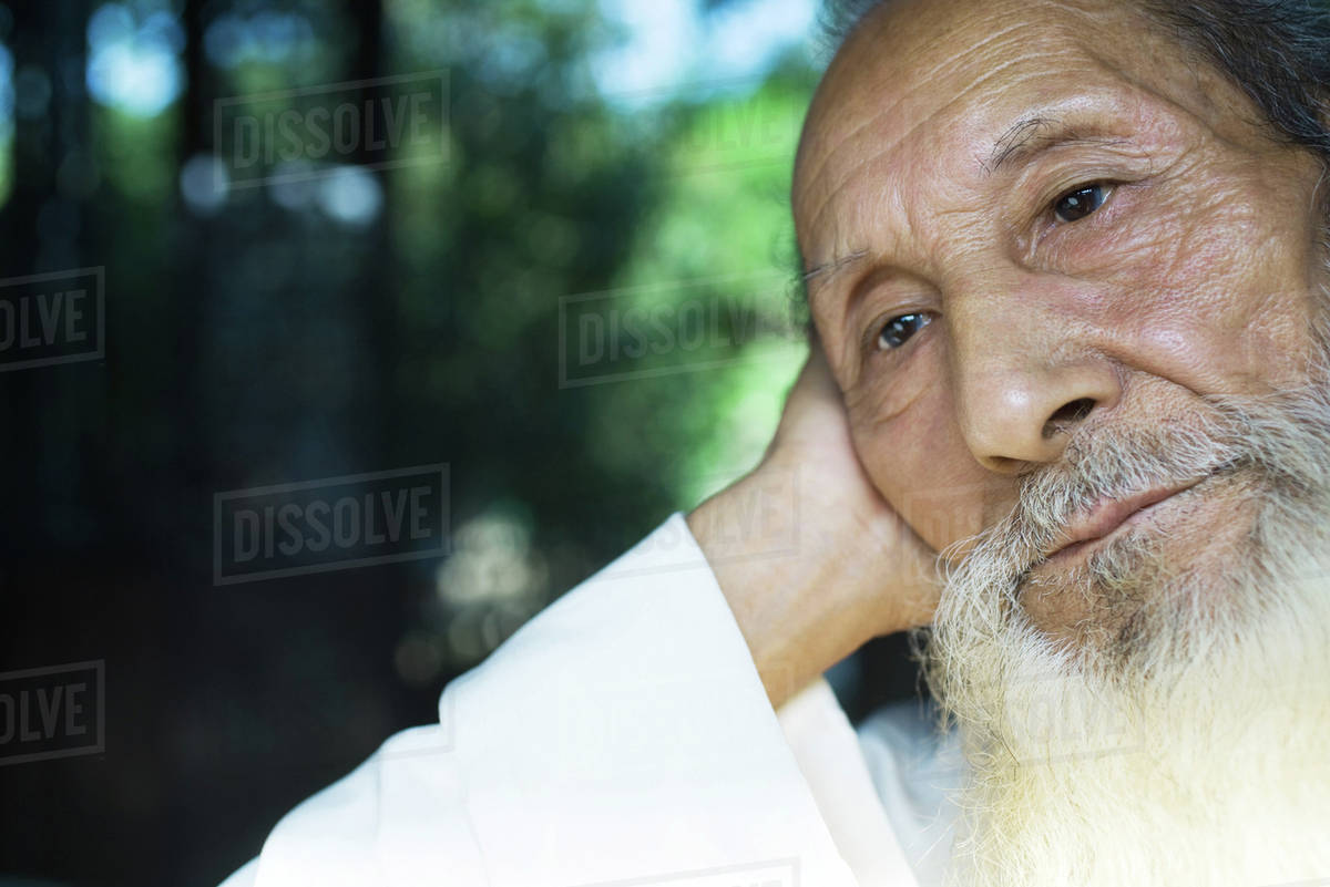 Elderly man leaning head against hand, looking away, close-up - Royalty ...