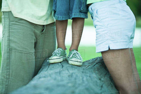 Boy standing between parents, cropped low section - Royalty-free Stock ...