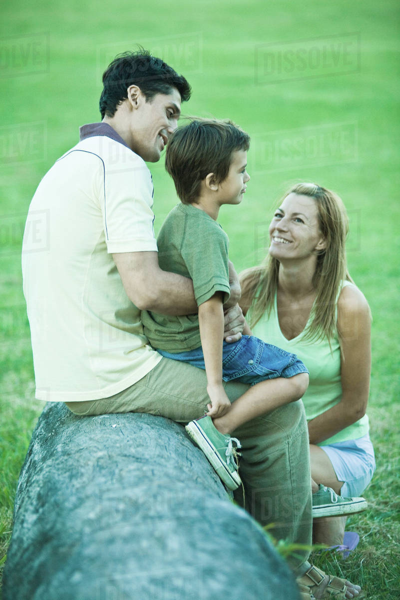 Boy with parents, sitting on father's lap - Stock Photo - Dissolve