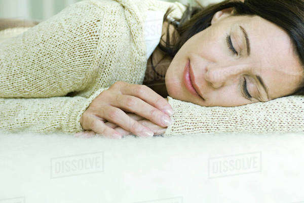 Woman resting head on arm, smiling, eyes closed - Royalty-free Stock ...