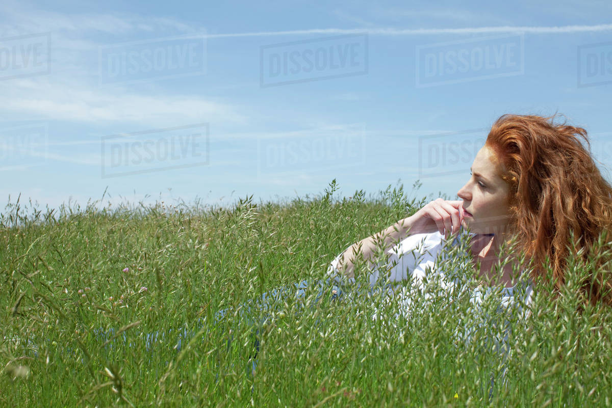 Woman relaxing in grass - Royalty-free Stock Photo | Dissolve