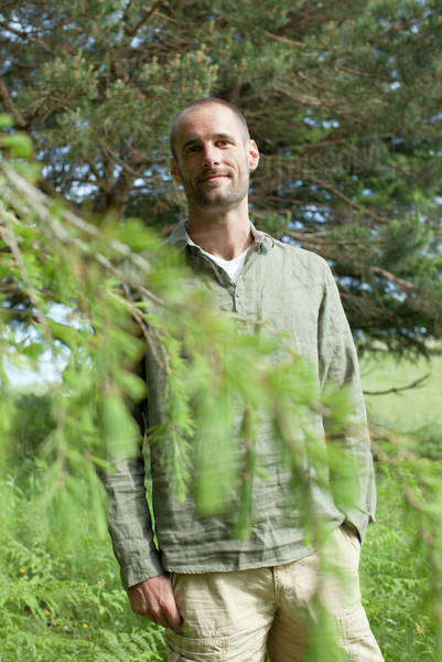 Man standing outdoors, portrait - Royalty-free Stock Photo | Dissolve