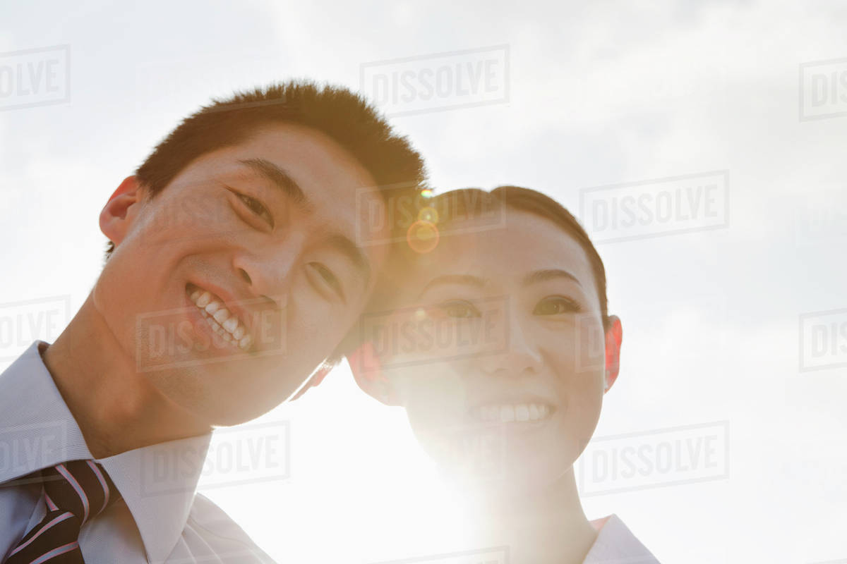 Portrait of two young business people leaning forward, close-up ...