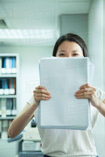 Businesswoman Hiding Behind Paper - Royalty-free Stock Photo | Dissolve