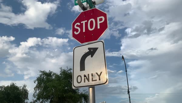 Right only turn and stop road sign on the background of cloudy sky ...