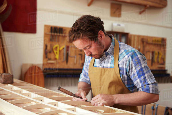 Man building bespoke wooden surfboard in workshop - Royalty-free Stock ...