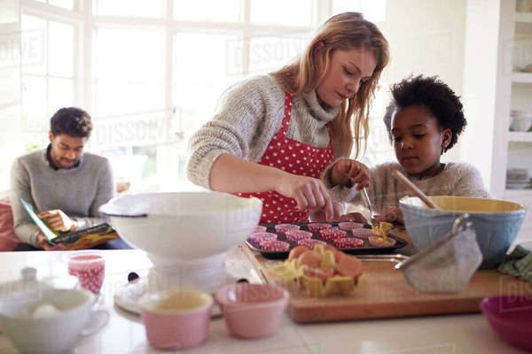 Family baking cake in kitchen at home together - Stock Photo - Dissolve