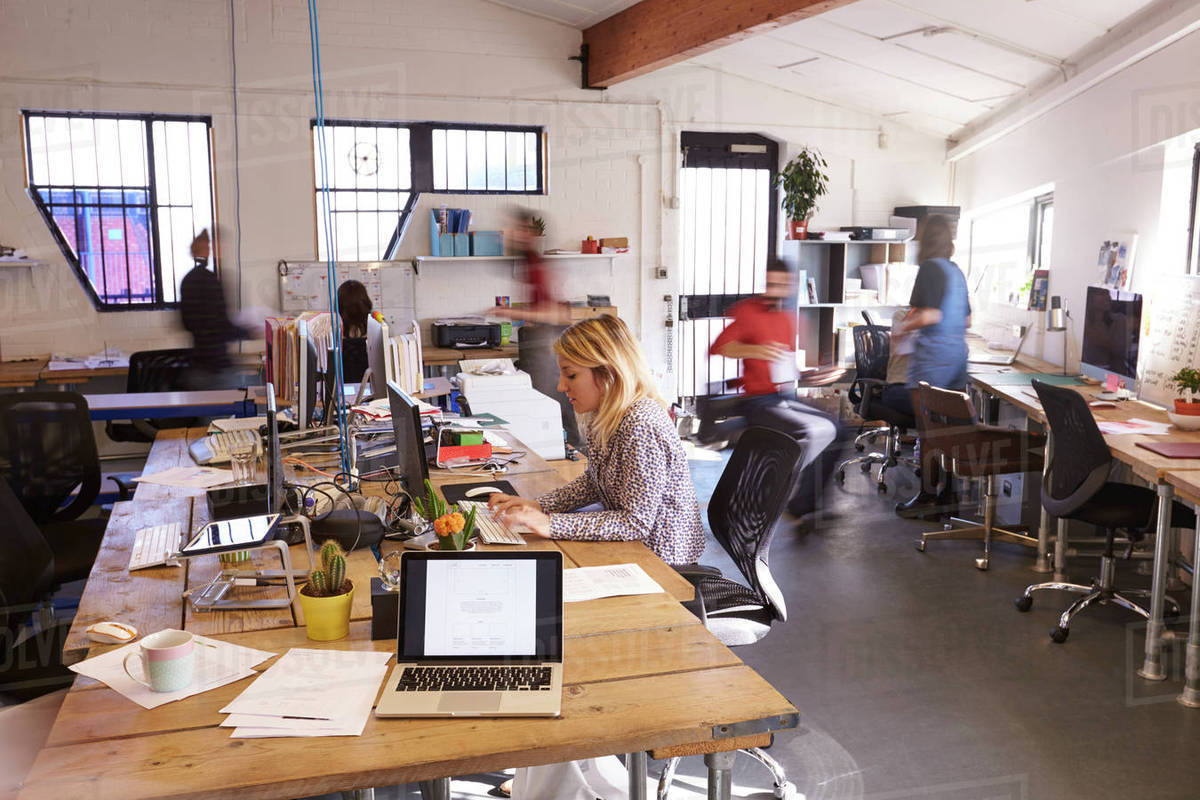 Interior of busy design office with staff - Stock Photo - Dissolve