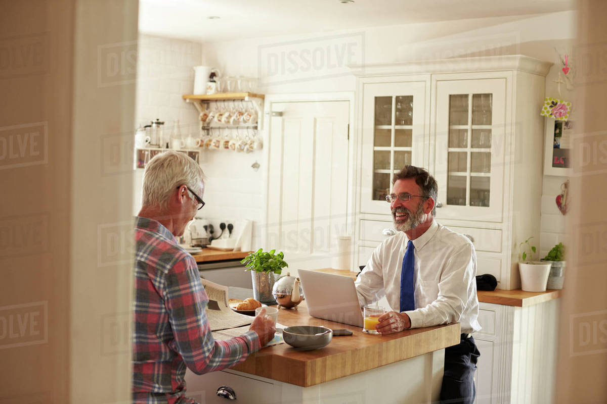 Male couple talking over breakfast, three quarter length - Stock Photo ...