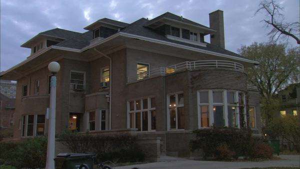 Static shot of a two story Craftsman style house in a park in Chicago ...