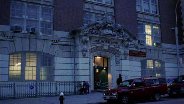 Static shot of entrance of a public school building at night in New ...
