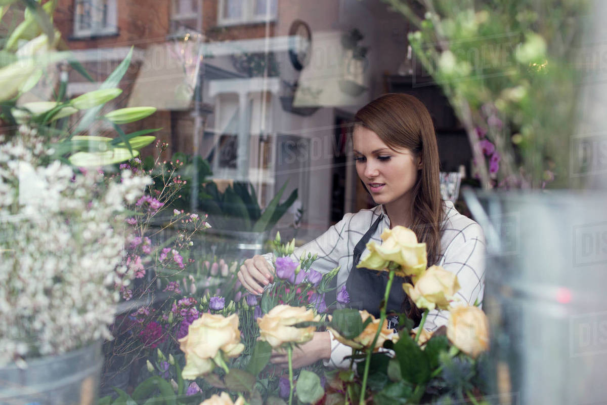 Female florist at work in shop - Royalty-free Stock Photo | Dissolve