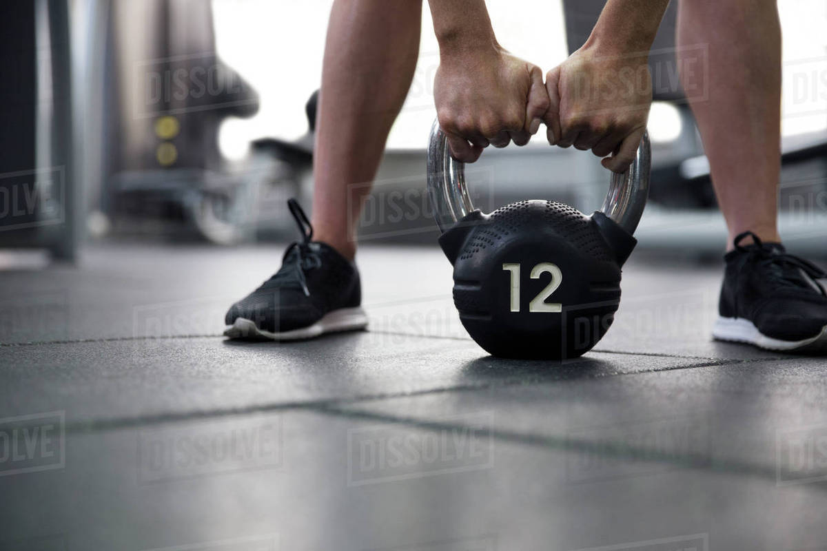 Close-up of young woman lifting weights in gym - Royalty-free Stock ...