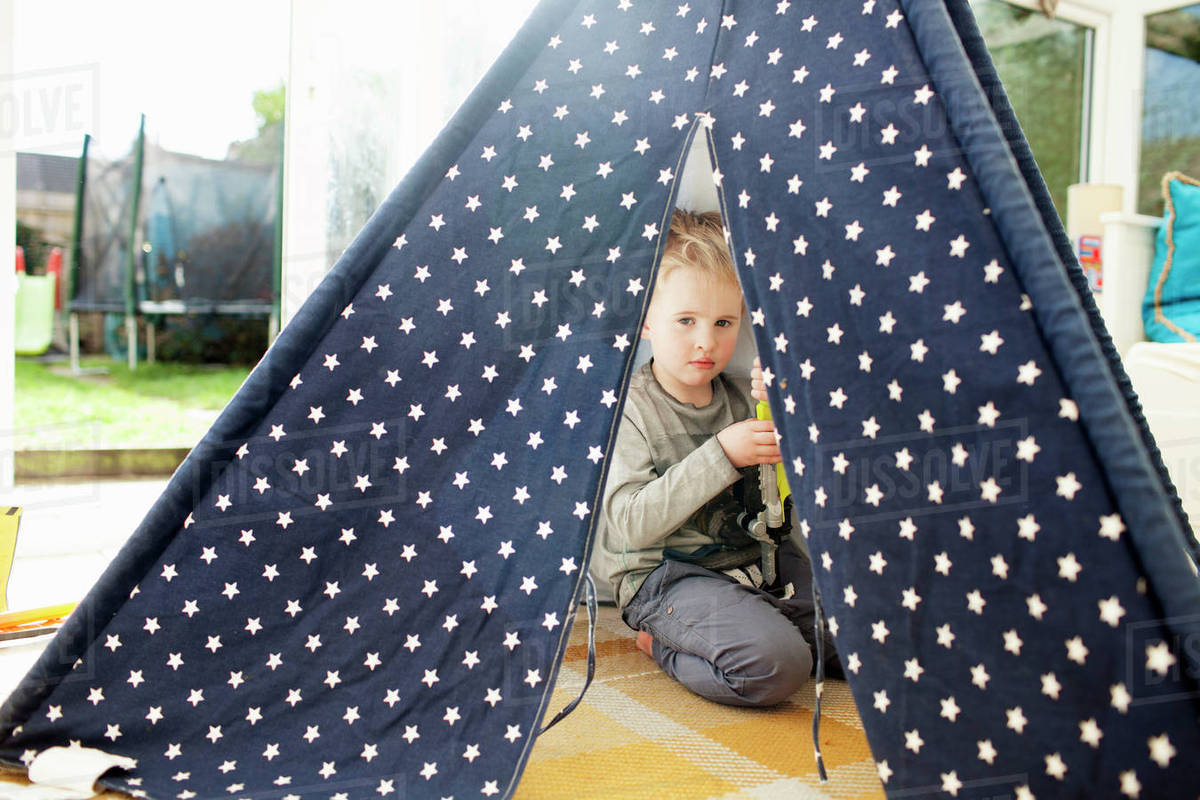 Boy playing inside tent at home - Royalty-free Stock Photo | Dissolve