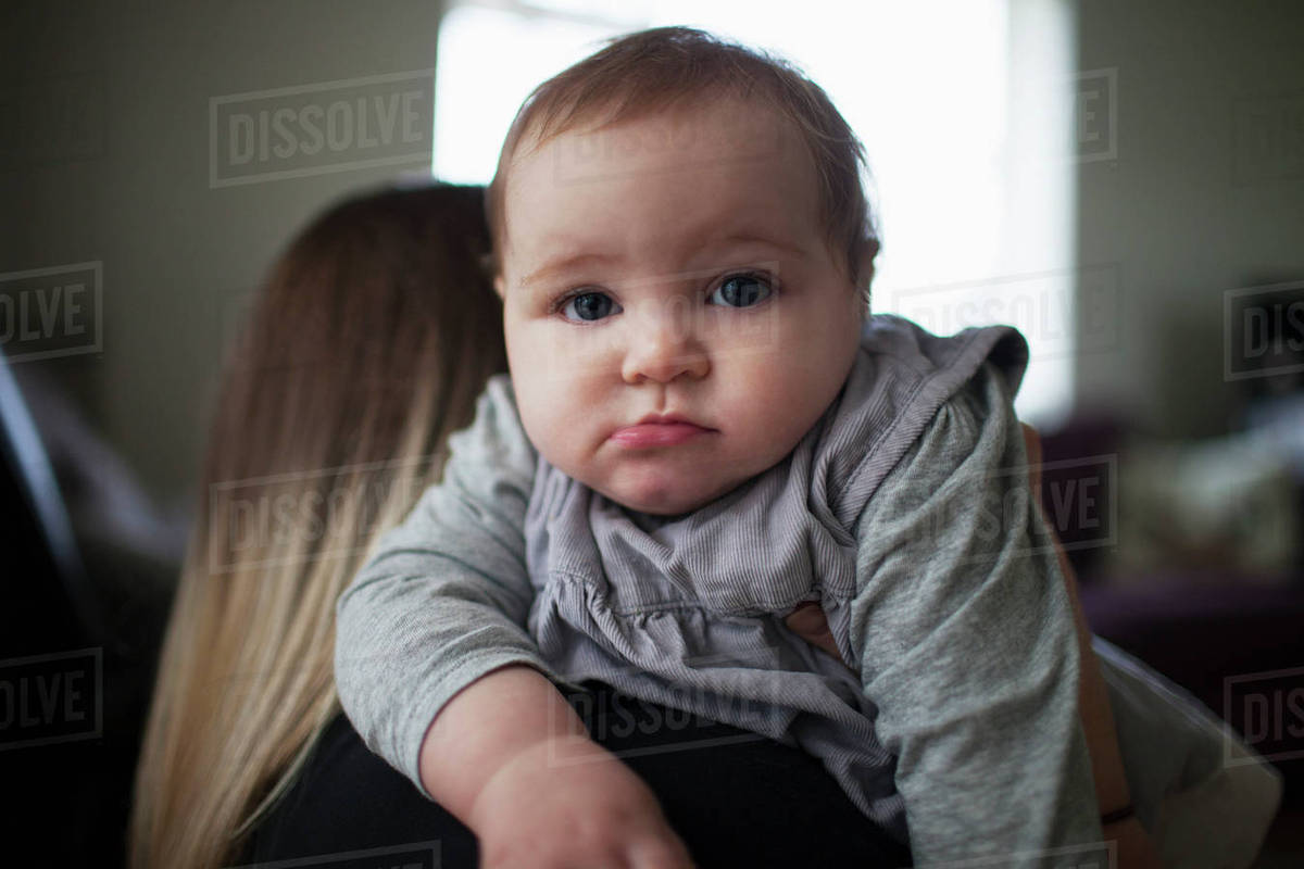 Baby girl being cuddled by mother at home - Royalty-free Stock Photo ...