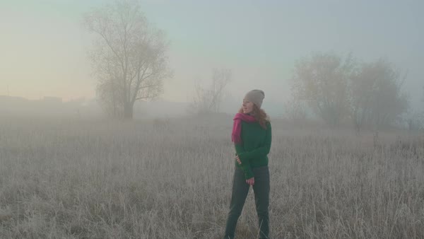 Woman tourist walks into the fog and enjoys nature. - Stock Video ...