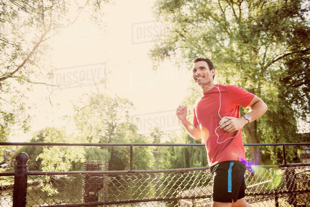 A man jogging through a park - Royalty-free Stock Photo | Dissolve