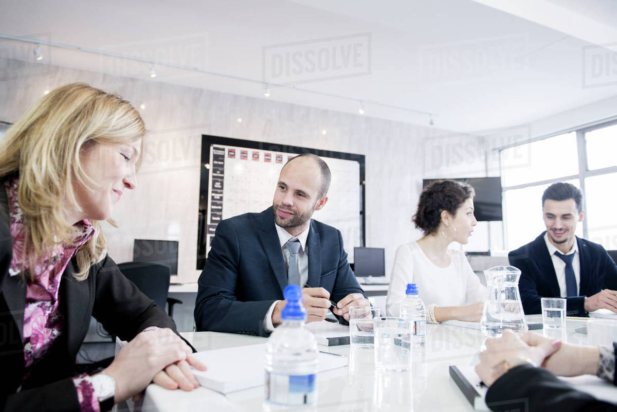 Professional people sitting in an office environment having a ...