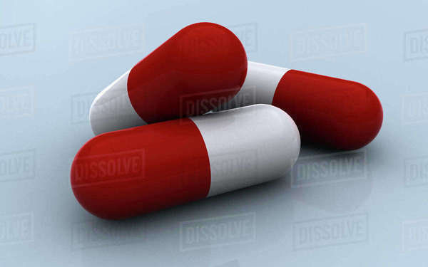 Red and yellow medication capsules on colored background. - Stock Photo ...