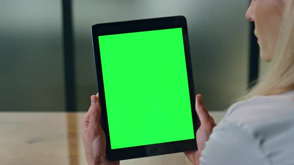 Greenscreen pad woman hands holding at office close up. Lady watching ...
