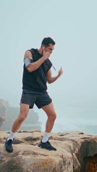 Strong male boxing fight on cliff vertically. Professional boxer ...