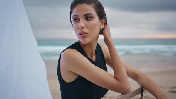 Charming woman posing coast closeup. Fashion model shooting rest chair ...