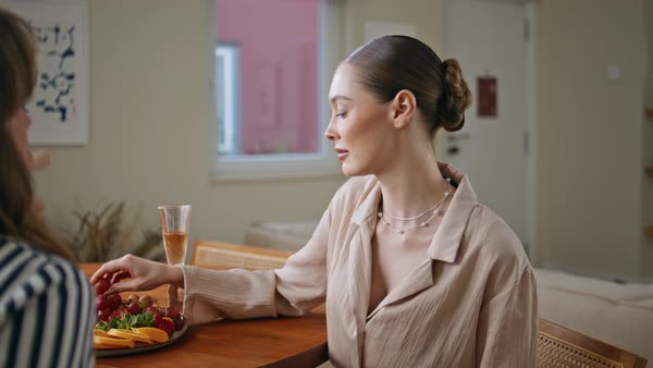Elegant lady enjoy friendly meeting at home with fruits and drinks ...