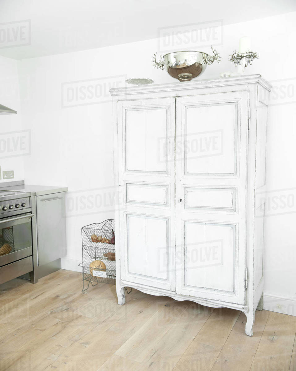 White painted cupboard unit in kitchen of cottage interior, UK. - Stock ...