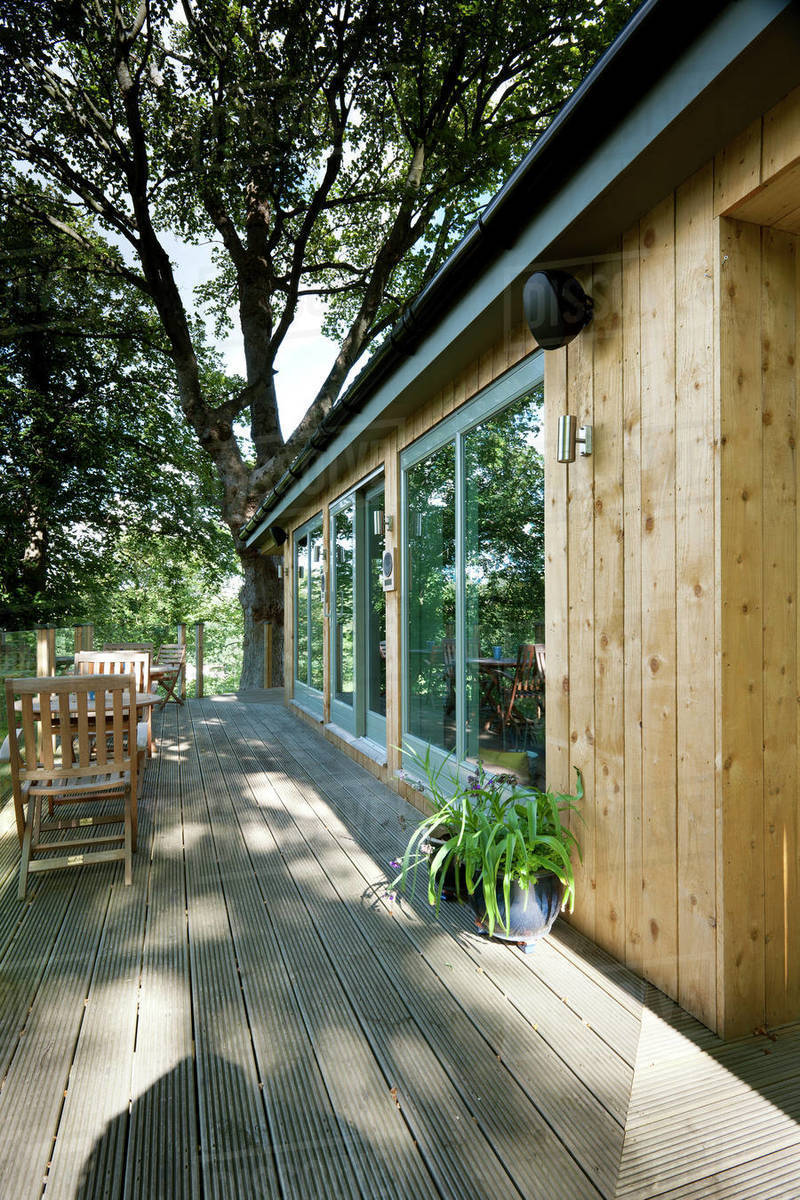 Timber bungalow with terrace - Stock Photo - Dissolve
