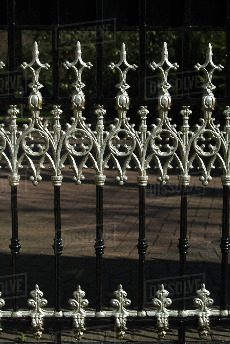 Close up of elaborate white finials on black metal railings. - Royalty ...