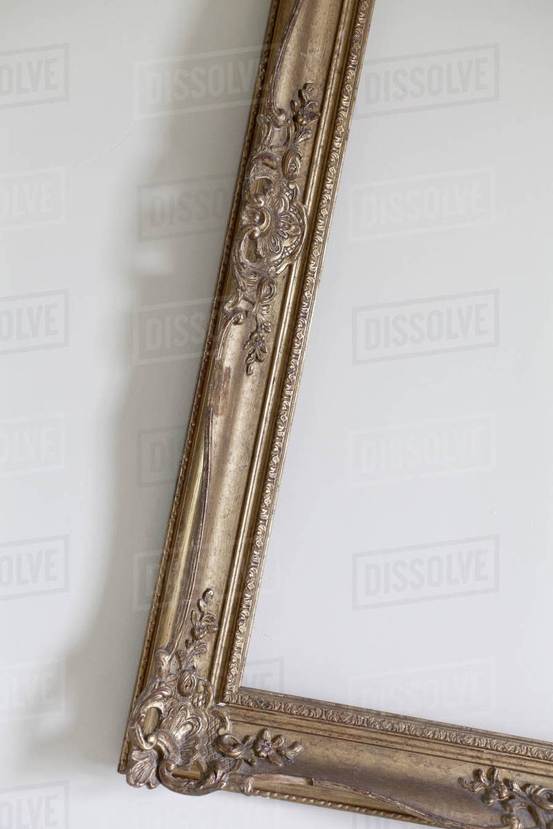 Edge of empty gilt picture frame - Stock Photo - Dissolve