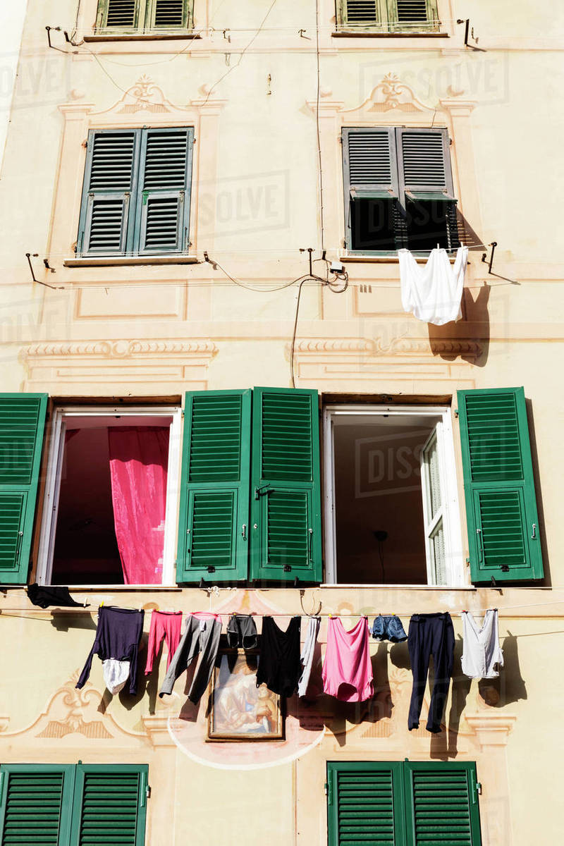 Washing hanging out of a window - Stock Photo - Dissolve