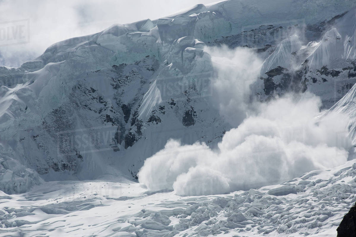 Avalanche rolling down mountain, Llaca glacier surrounding Cordillera ...