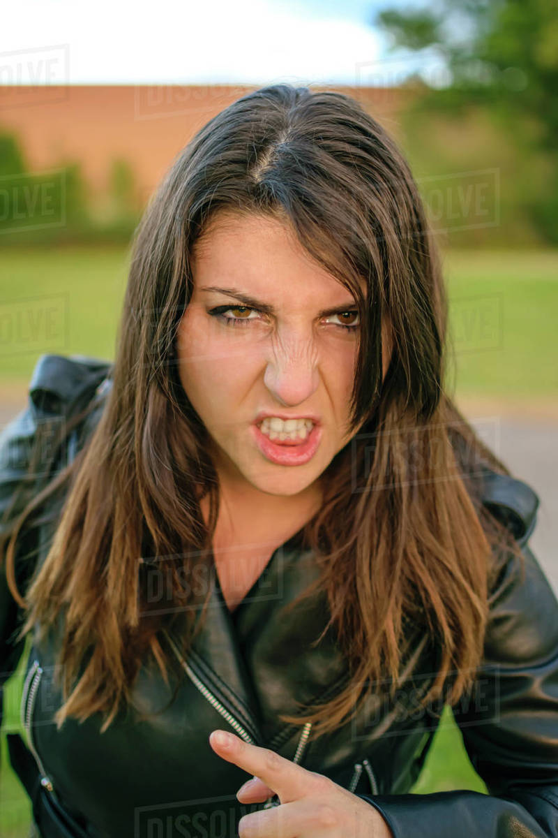 Young sexy woman very angry with aggressive face and pointing with finger. Discussion, problems ...
