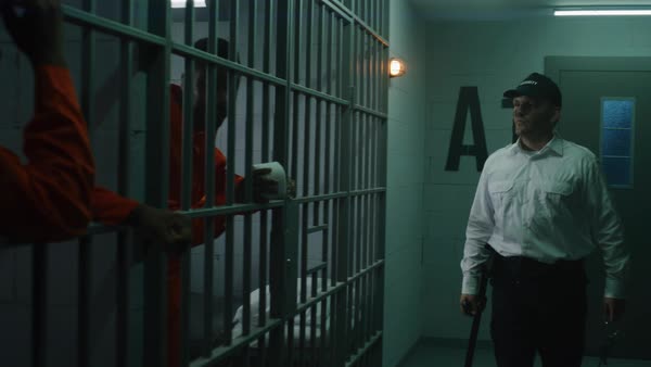 Warden with baton bullying prisoners in jail cells - Stock Video ...