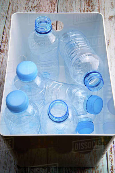Overhead view of closed and open plastic bottles placed in white ...