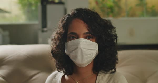 Stay home stay safe, woman at home wearing face mask in self isolation ...