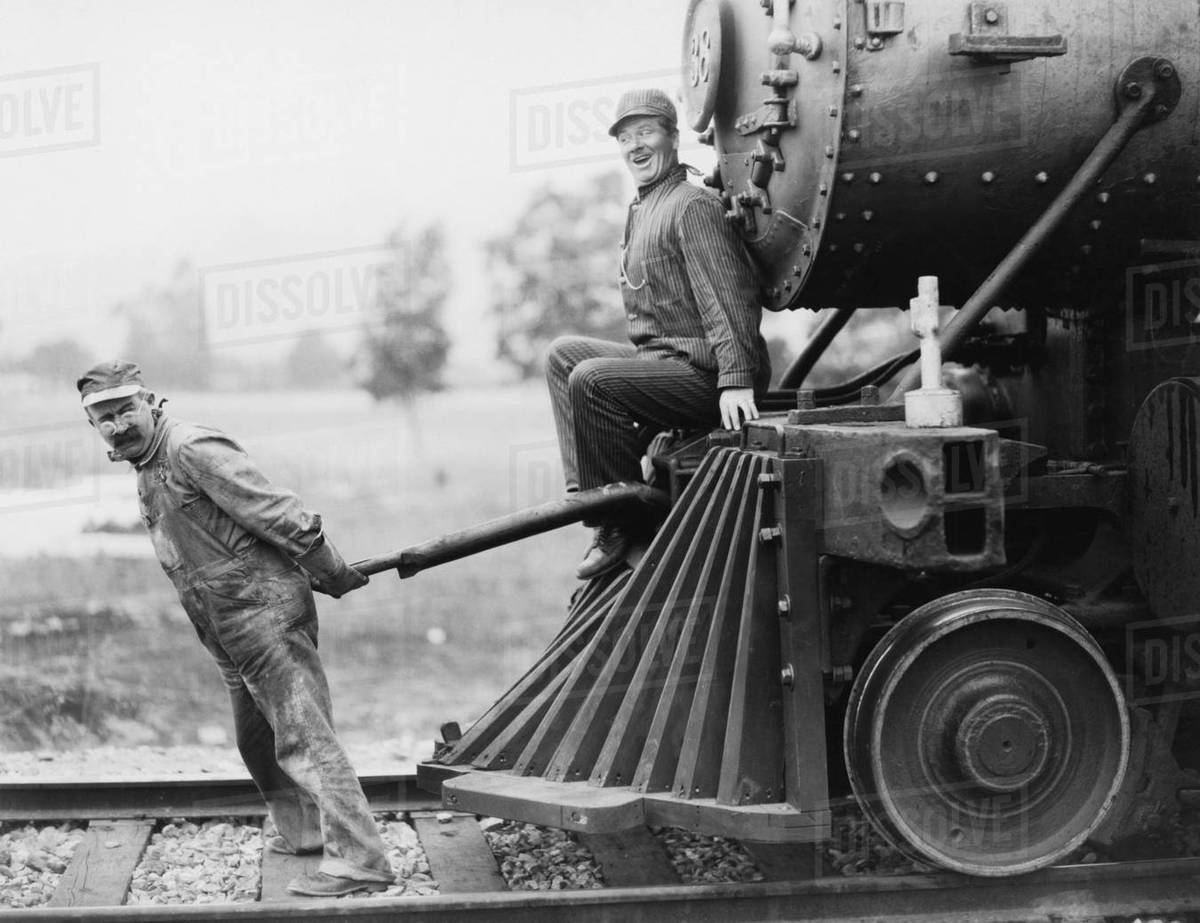 Engineers pulling train engine - Stock Photo - Dissolve