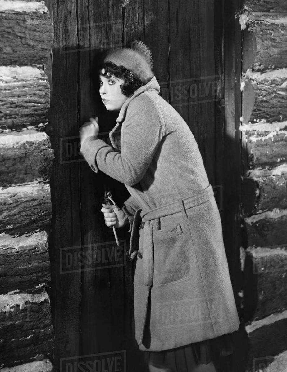 Woman knocking on cabin door - Royalty-free Stock Photo | Dissolve