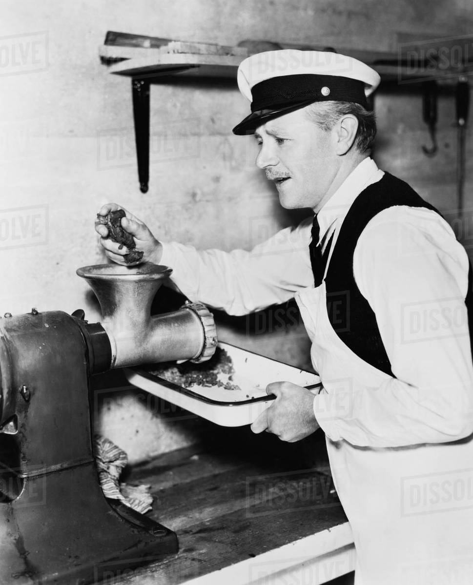 Butcher grinding meat - Royalty-free Stock Photo | Dissolve