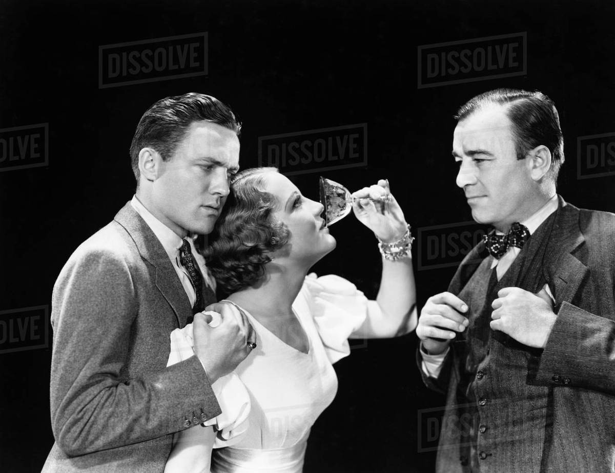 Two men supporting a woman drinking - Royalty-free Stock Photo | Dissolve